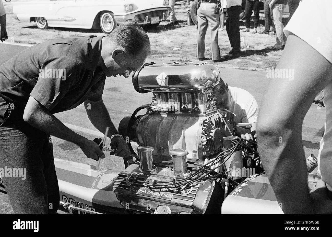 Here Ed McCulloch's mechanics work on the power plant of his machine, a ...