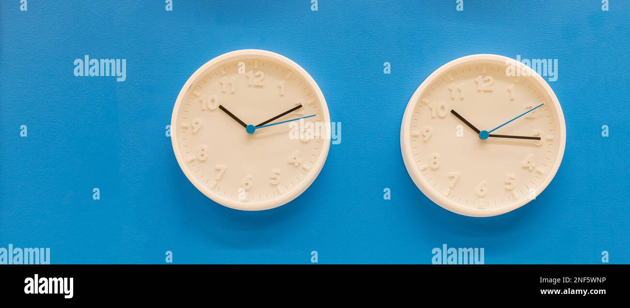 White big analogue plain wall clock on trendy pastel blue background ...