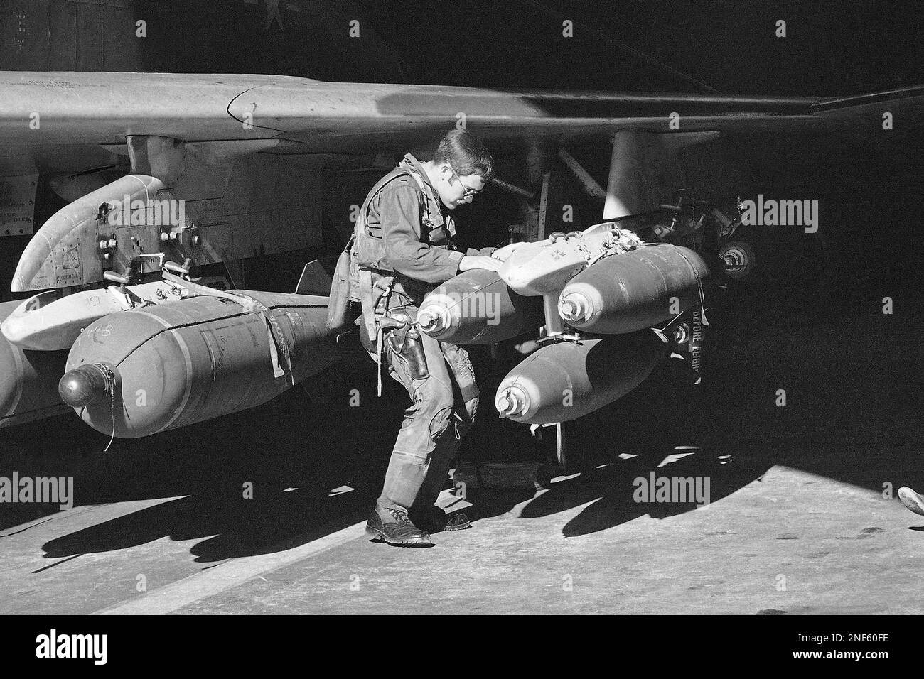 U.S. Air Force pilot checks bomb load on his phantom fighter-bomber at ...