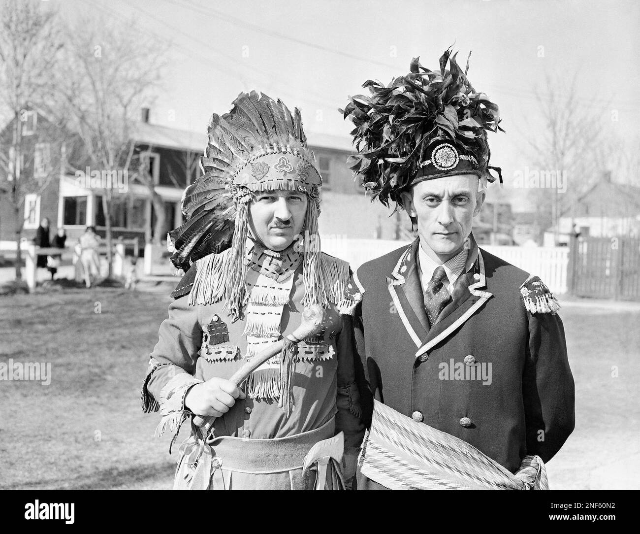 The close up of the two Indians in war bonnets shows Jules Sioui (left ...
