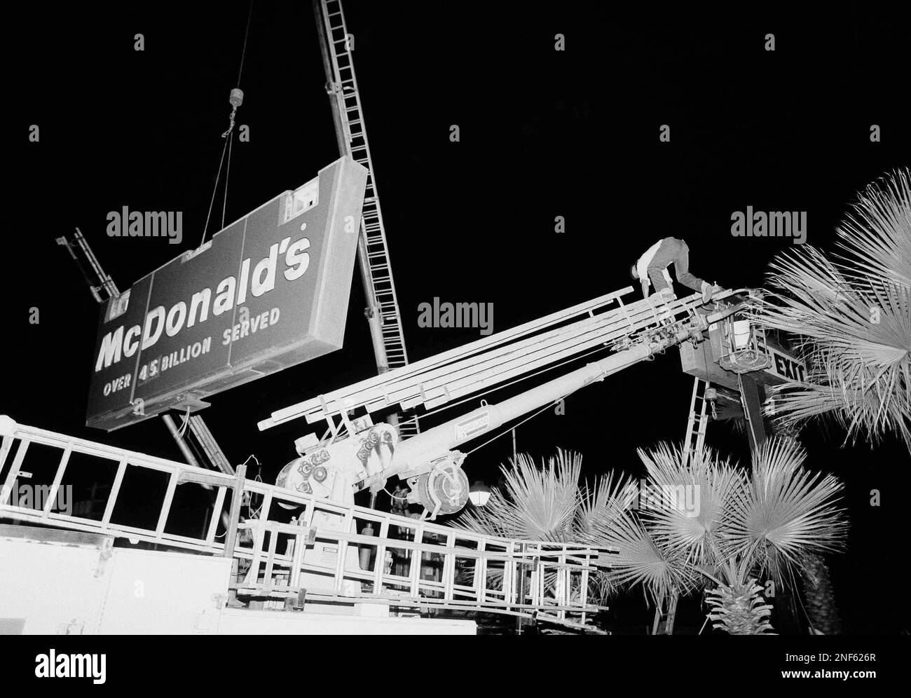 Workers remove all McDonald's Corporation emblems from the fast-food ...