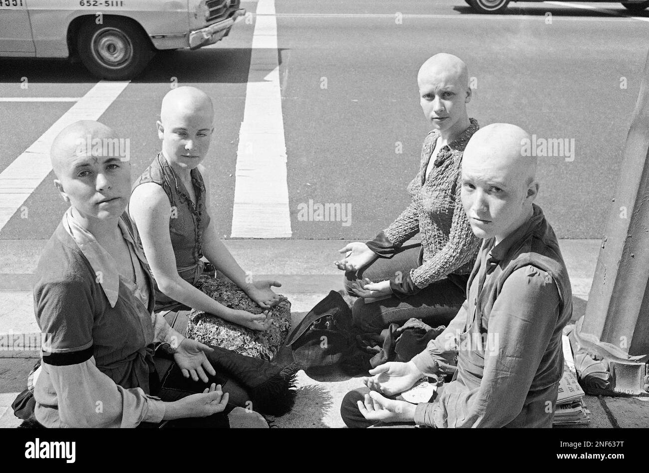 Four young women members of the Charles Manson "family" kneel on the ...