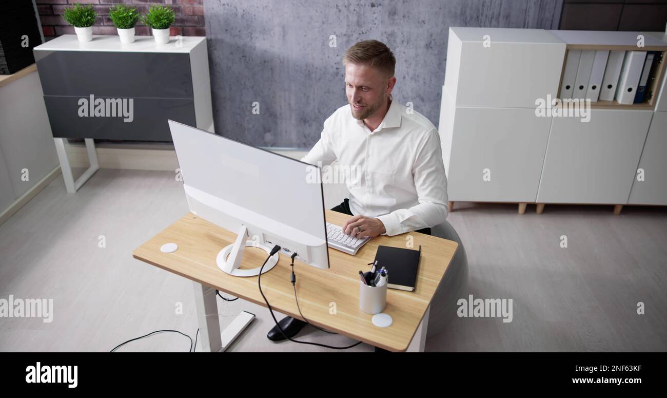 Office Ball Exercise. Sitting Posture At Desk Stock Photo - Alamy