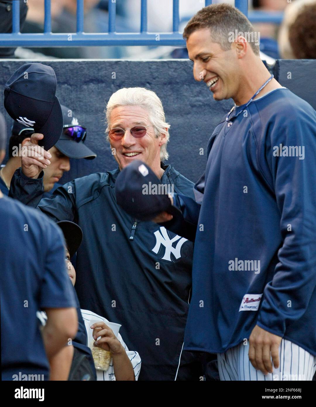 Actor Richard Gere and New York Yankees pitcher Andy Pettitte share a laugh after Gere doffed ...
