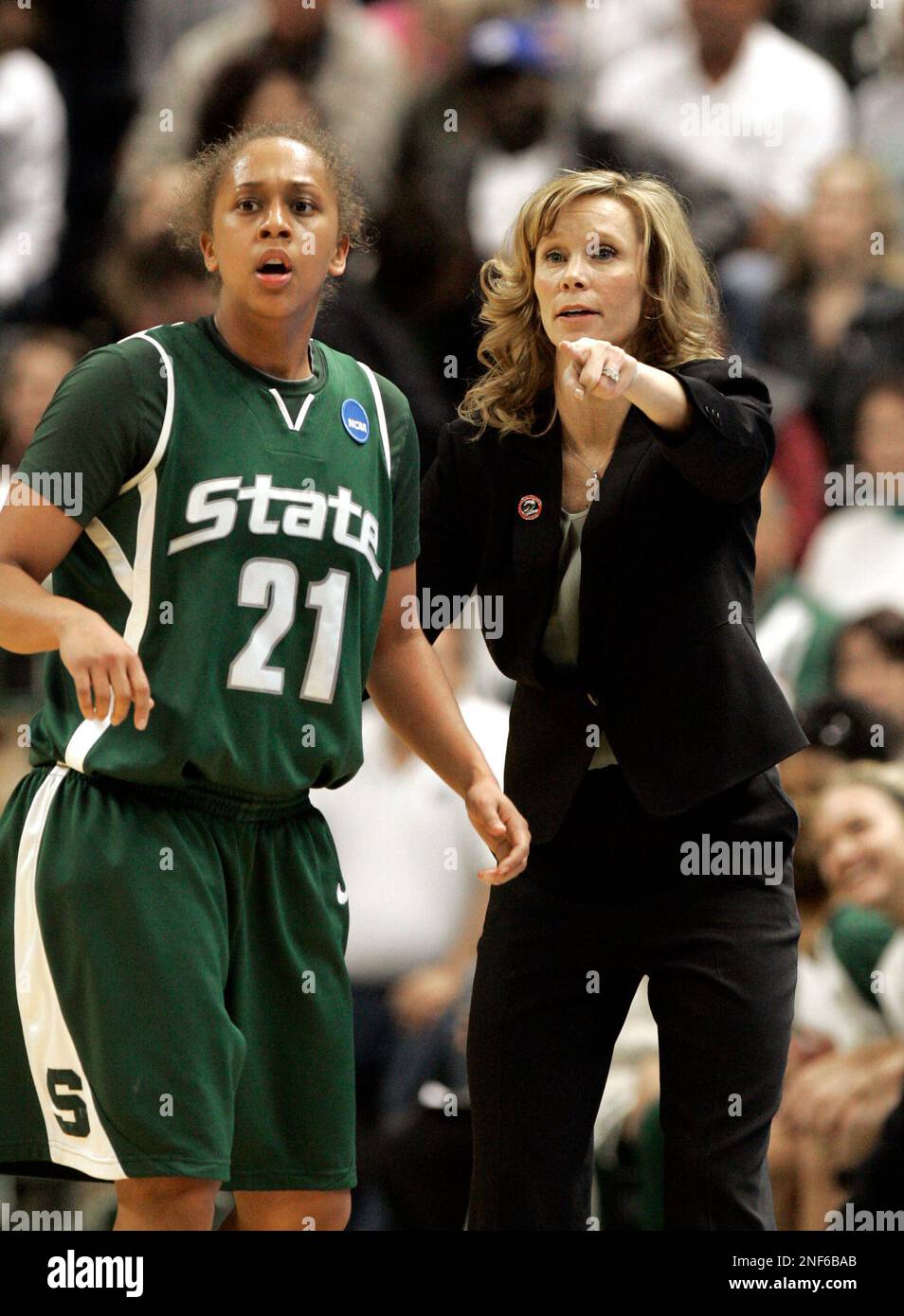 Michigan State head coach Suzy Merchant is seen with guard Mia Johnson ...