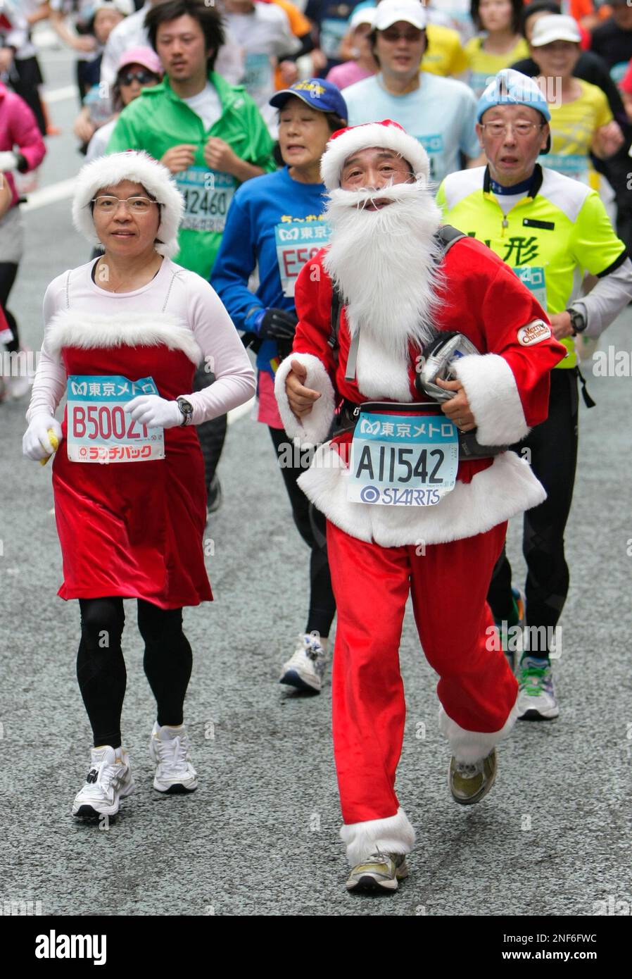 A runner dressed as Santa Claus participates in the Tokyo Marathon in ...