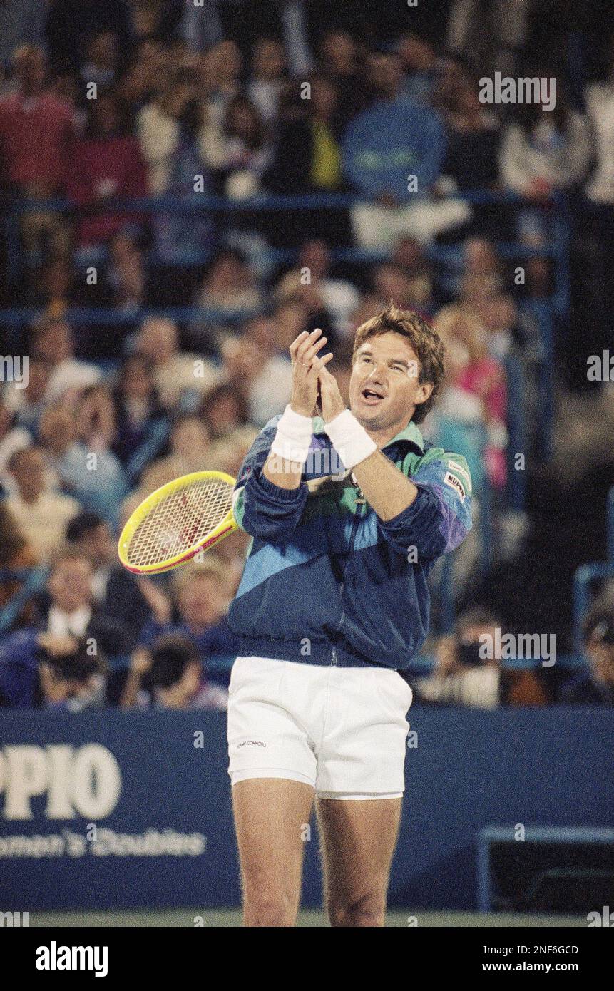 Jimmy Connors puts his racket aside to return applause from the crowd ...