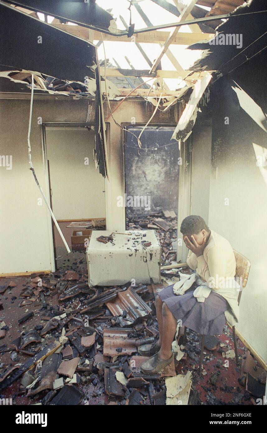 A woman weeps among the ruins of her home wrecked as savage faction ...