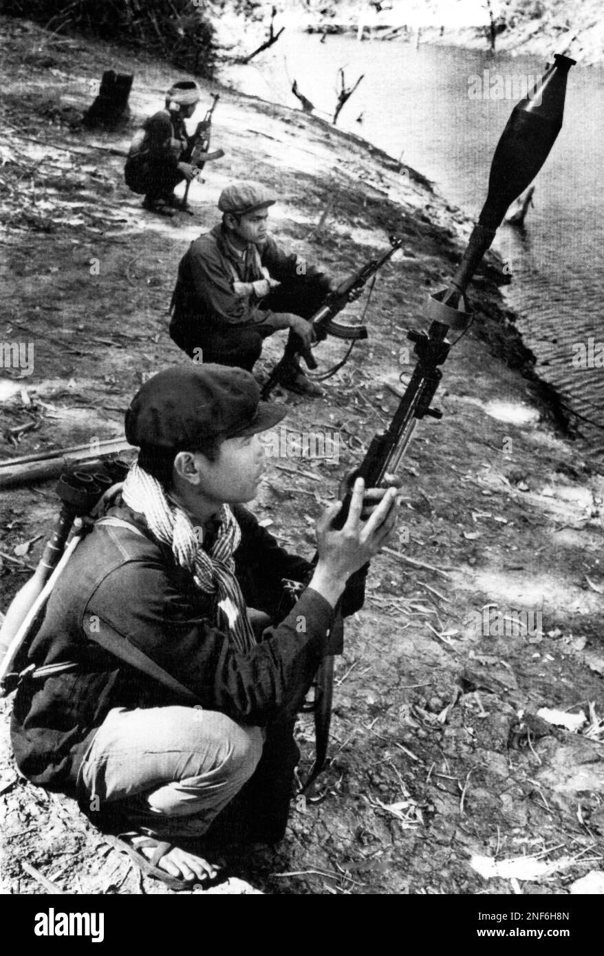 A group of Khmer Rouge Soldiers, taking refuge in Thailand, look out ...
