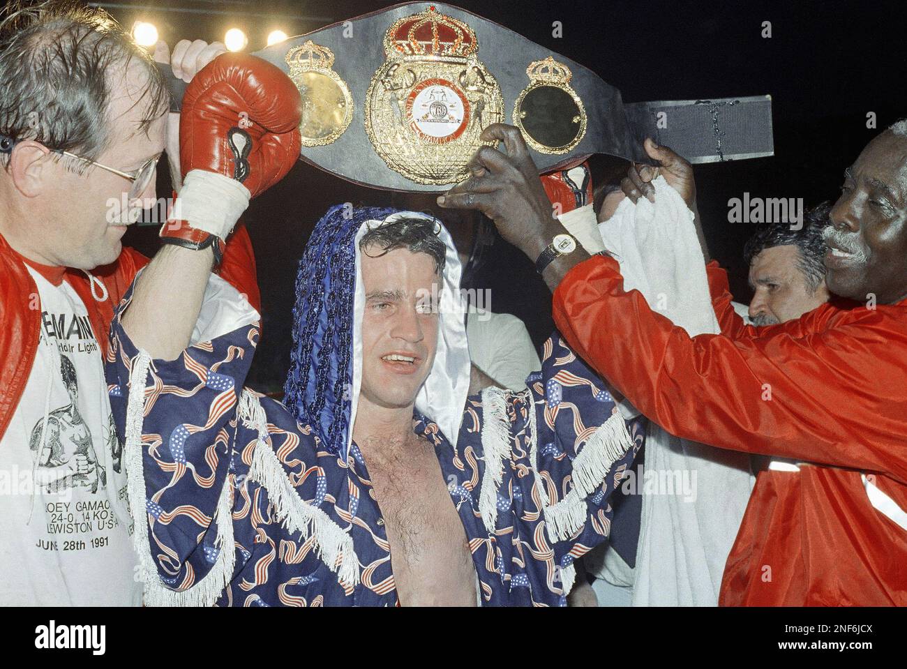 Joey Gamache, of Lewiston, Maine, center, holds up the title belt after ...