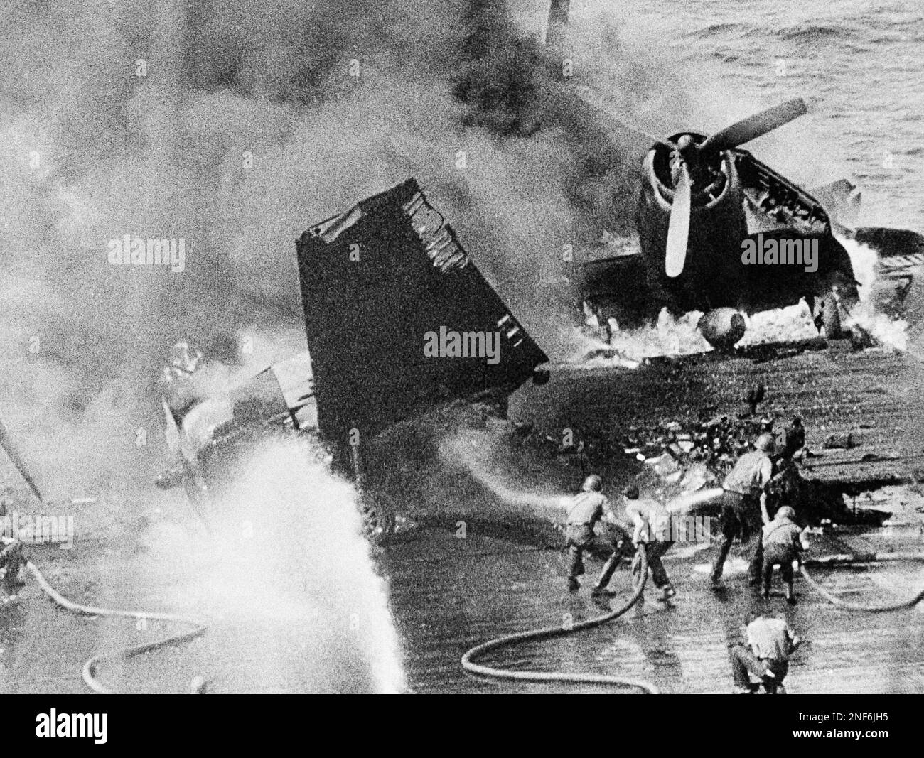 Firefighting crews of an unnamed U.S. carrier battle flames in two ...
