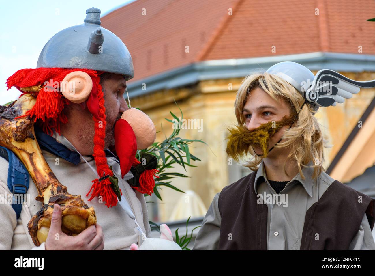 A shallow focus shot of people wearing masks and costumes at a carnival ...