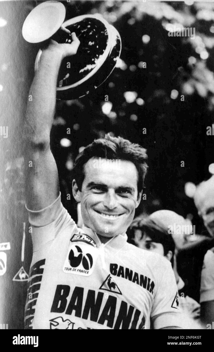 French champion Bernard Hinault holds up his trophy after winning for ...