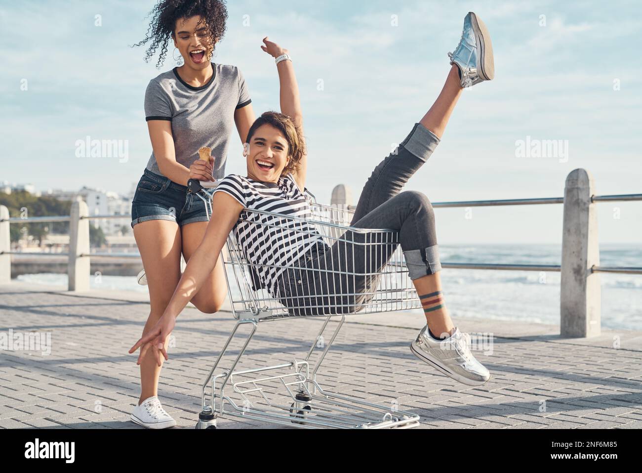 Good friends dont let you do stupid things alone. a young woman pushing ...