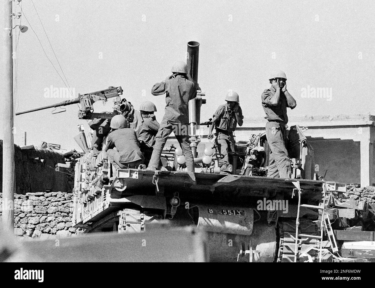 An Israeli mortar crew blocks their ears as they fire a round towards ...