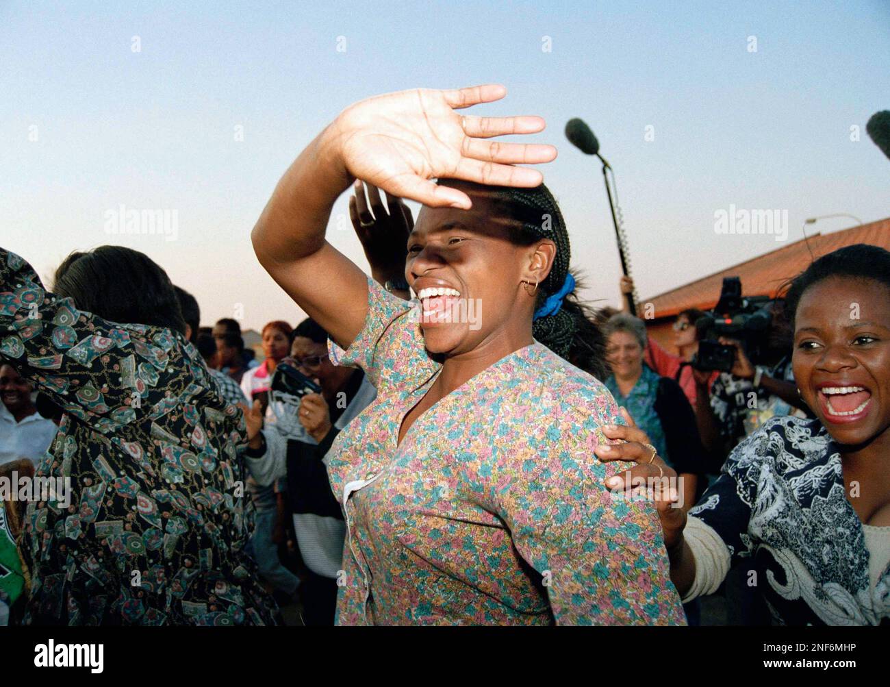 Supporters of Nelson Mandela waves as Mandela leaves the home of ...
