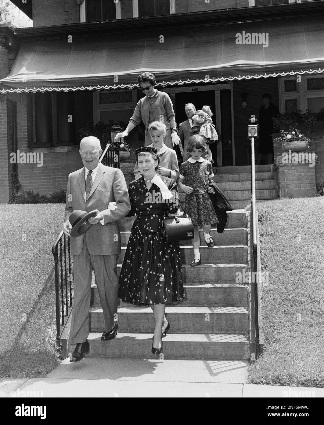 President Dwight Eisenhower and Mrs. Mamie Eisenhower are shown leaving ...