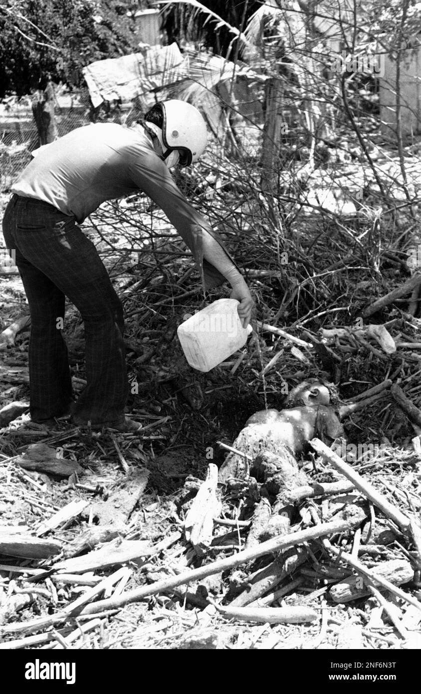 Rescue workers burn rotting corpses, in Choloma, Honduras, on Sept. 22 ...