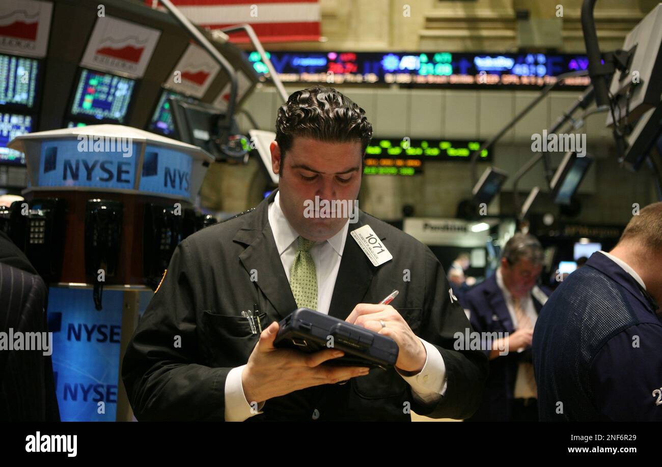 Trader Robert P. McQuade works the trading floor of the New York Stock ...