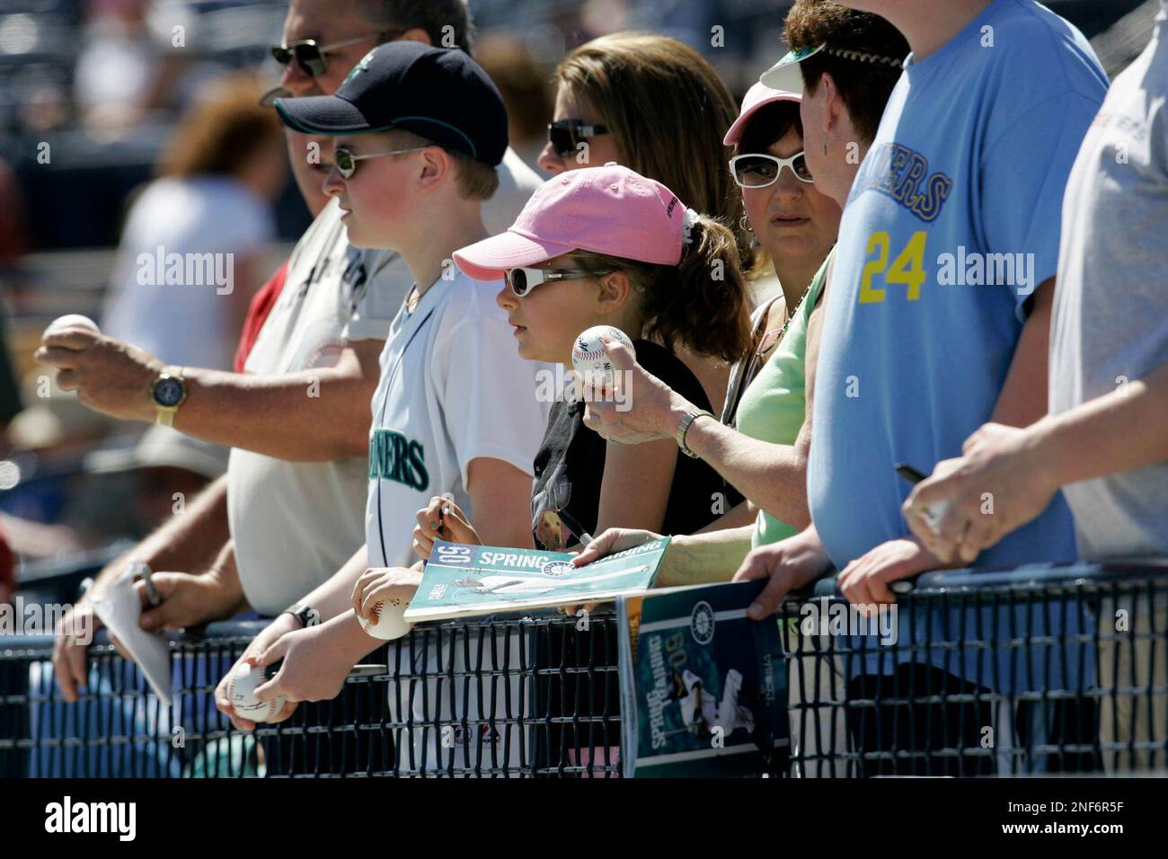 Baseball fans seek autographs before the start of a spring training ...