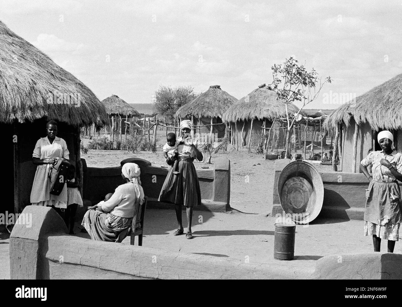A typical Bechuanaland village of mud huts and straw roofs is shown on ...