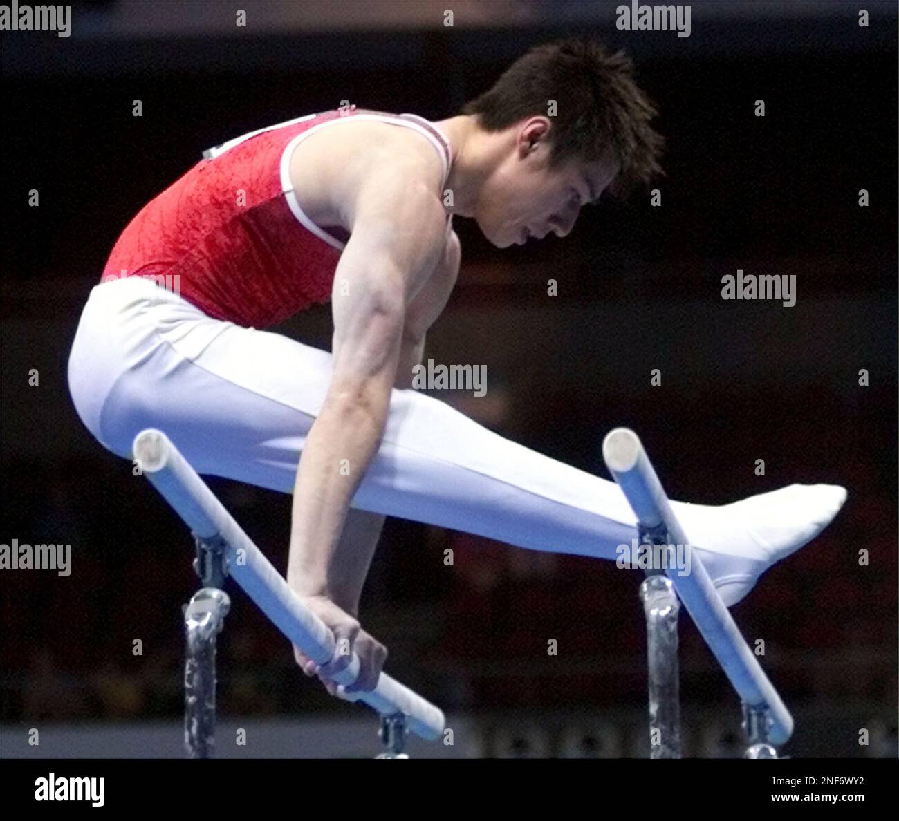 Yashihiro Saito of Japan competes on the parallel bars during the men's ...