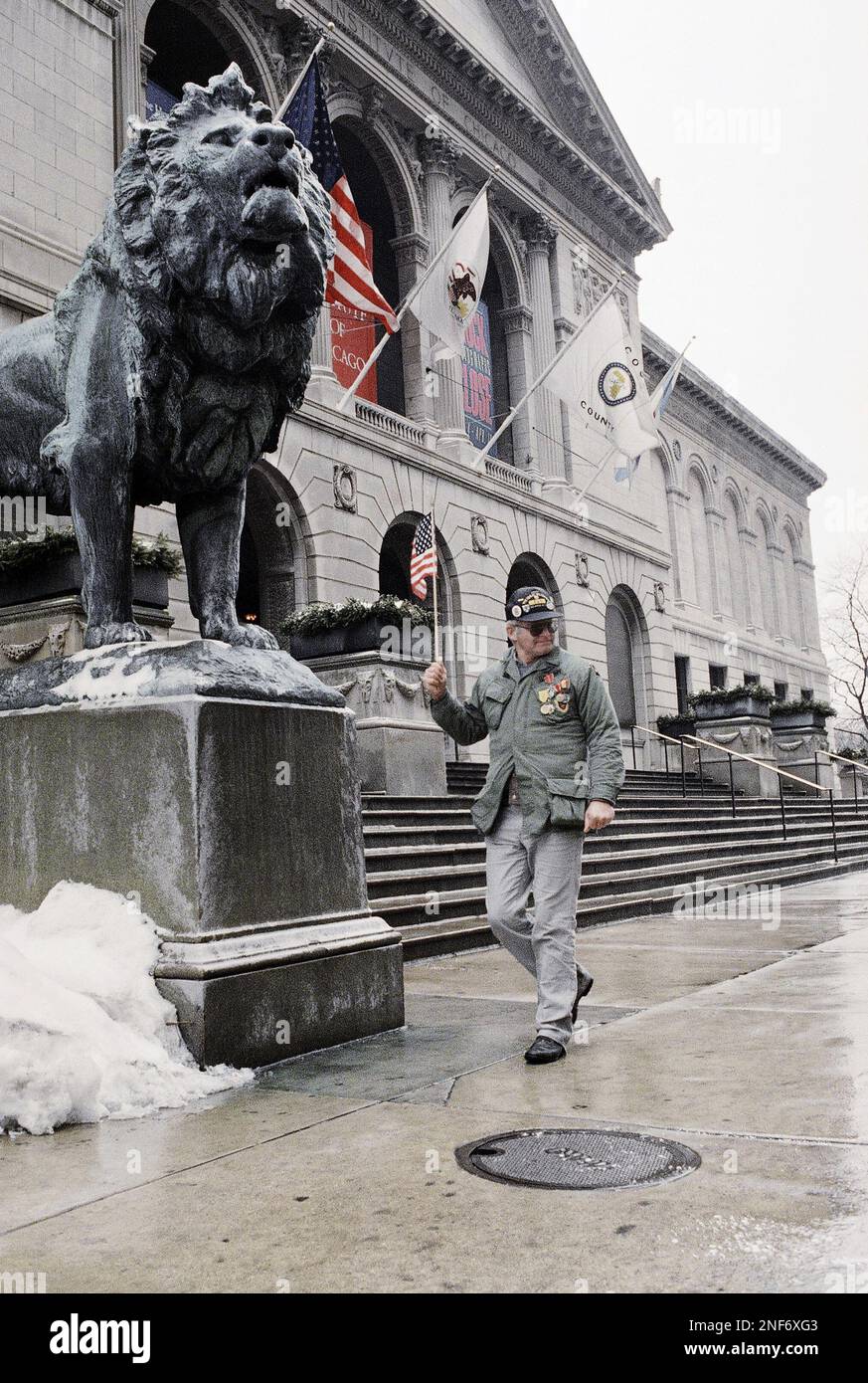 Veteran Jerry Peet of Joliet, Ill., carries an American flag on Friday ...