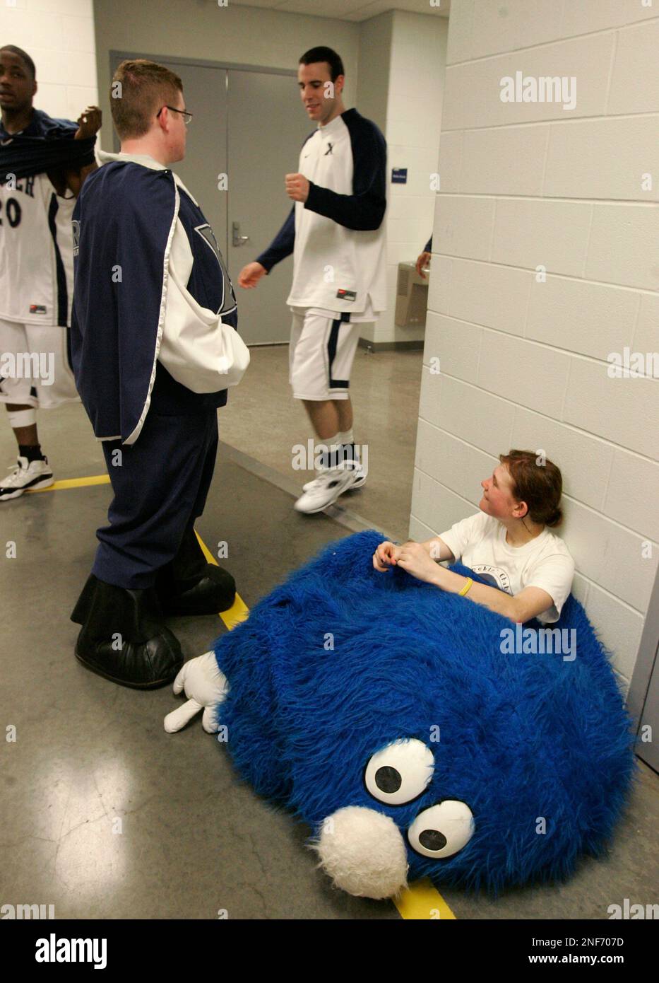 Xavier mascot Arick Stall, wearing the costume of D'Artagnan, bumps ...
