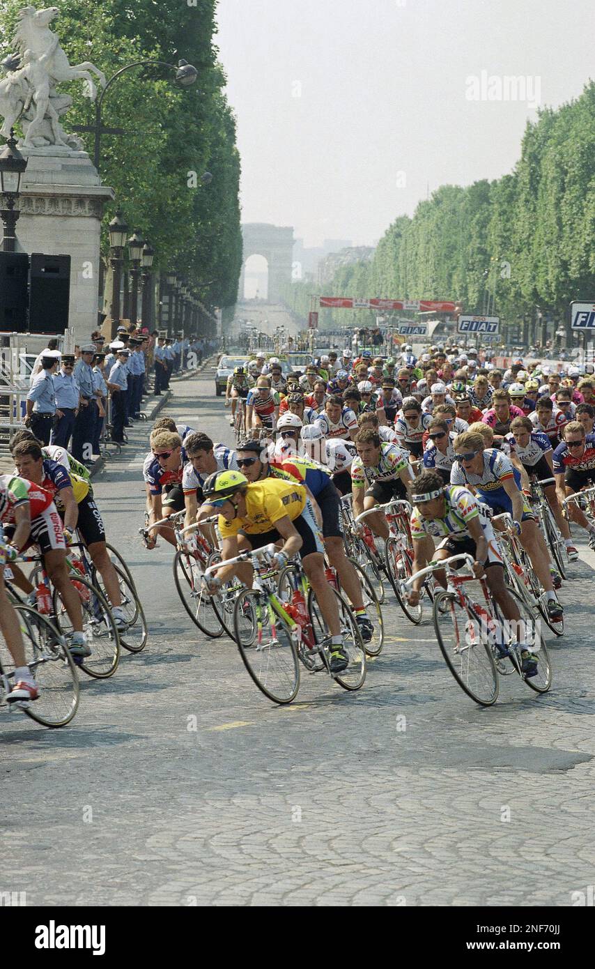 United States Greg LeMond, foreground, negotiates a curve with the pack ...