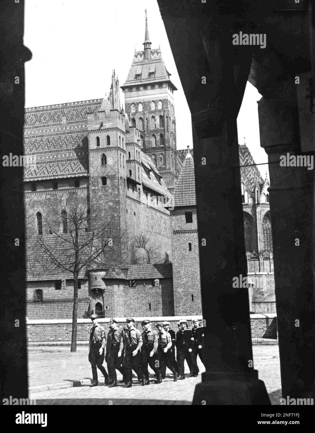 A squad of Hitler Youth march through one of the inner courtyards at ...