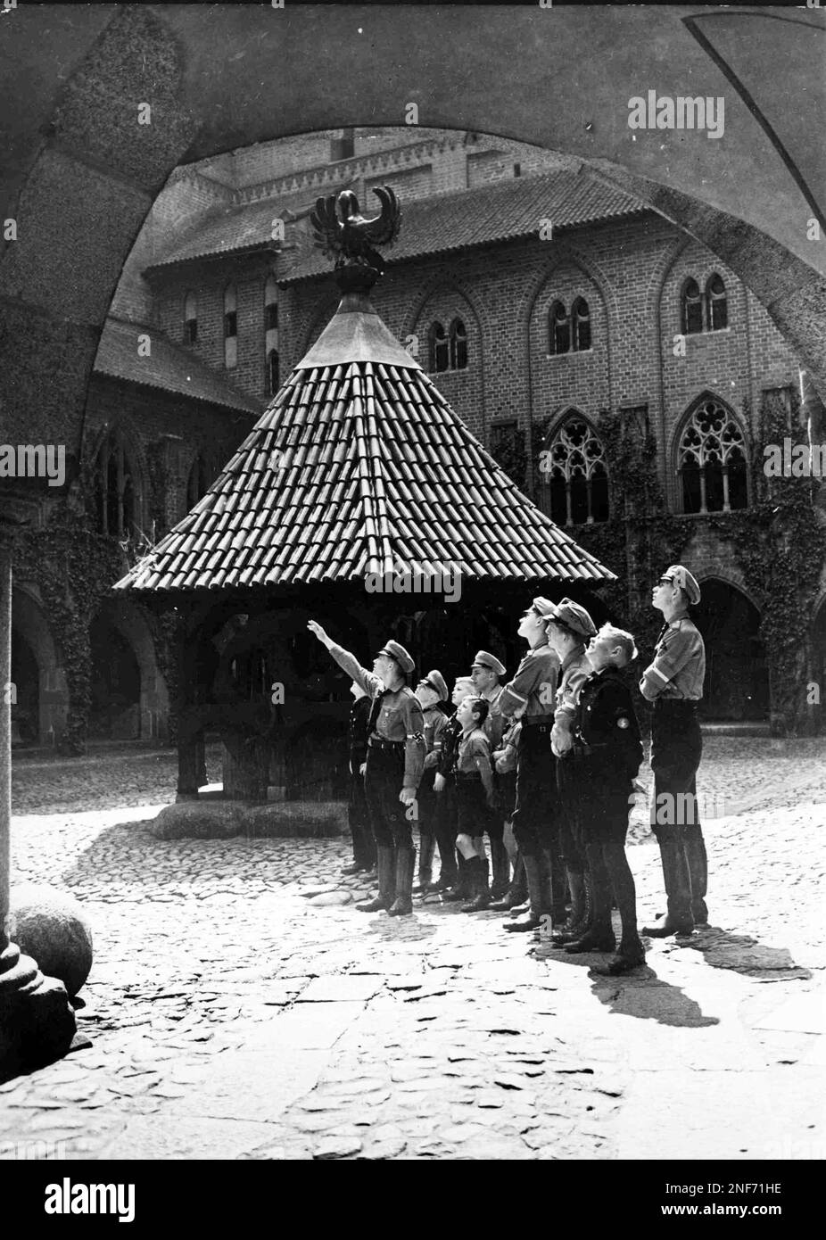 A squad of Hitler Youth look at the architecture in one of the inner ...