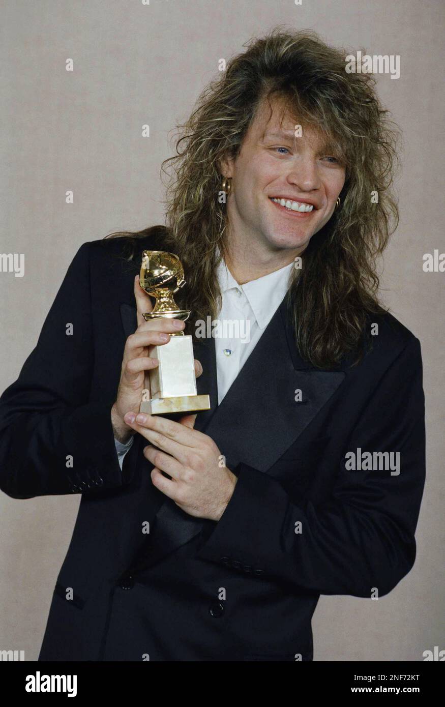 Singer Jon Bon Jovi, poses with a Golden Globe trophy, Jan. 18, 1991 ...