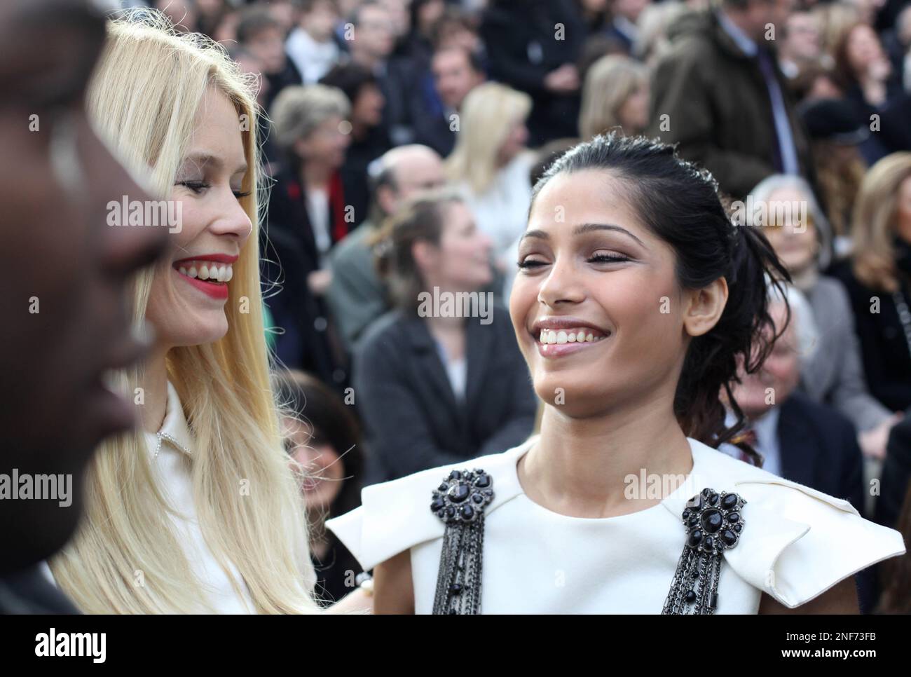 German model Claudia Schiffer, left, smiles with Freida Pinto, right ...