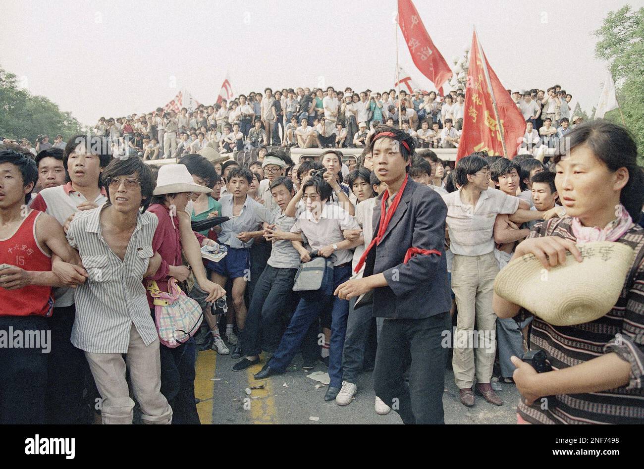Pro-democracy protesters link arms to hold back angry crowds from ...