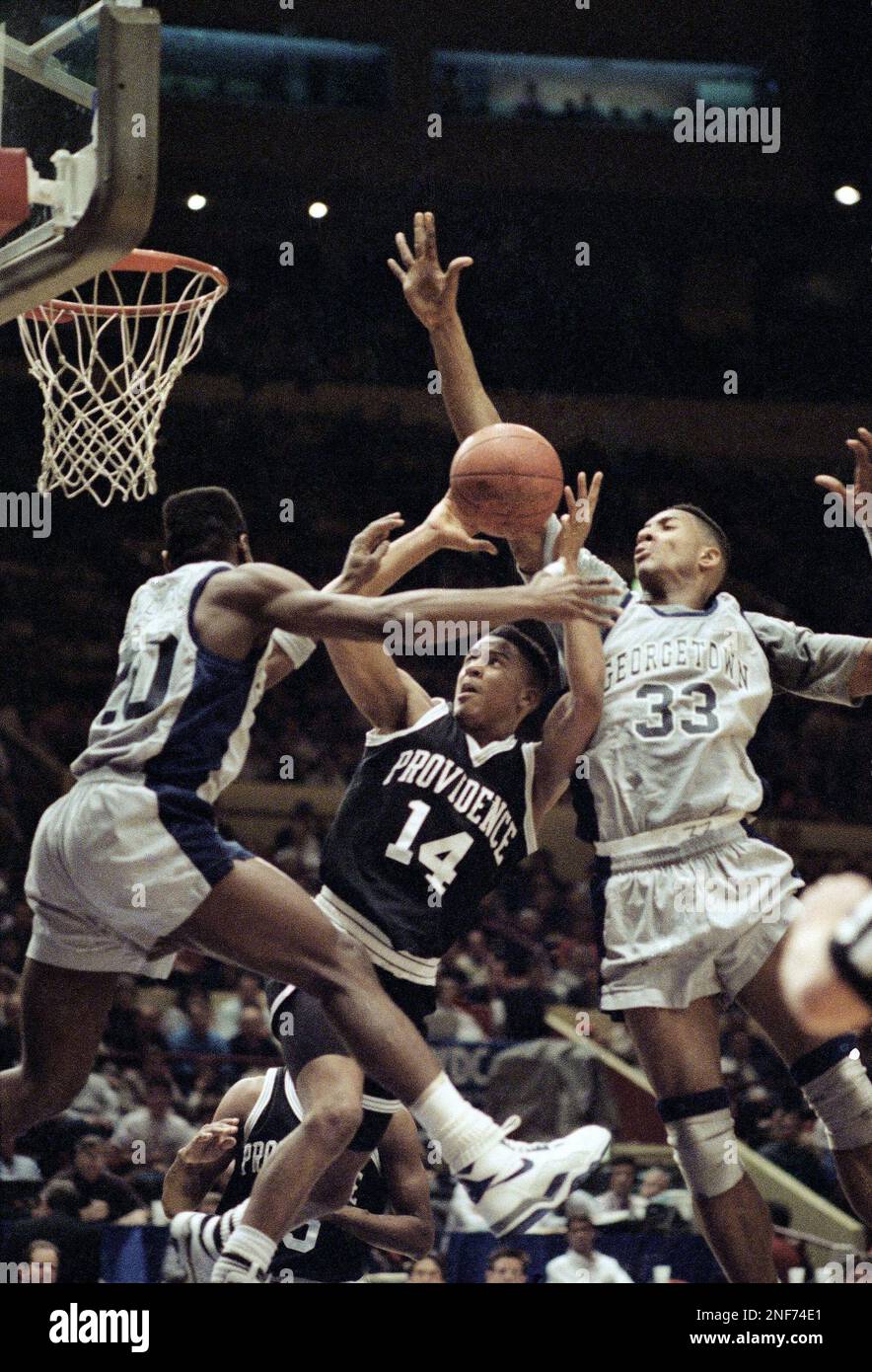 Providences Eric Murdock (14) aims for the basket as Georgetowns Mark ...