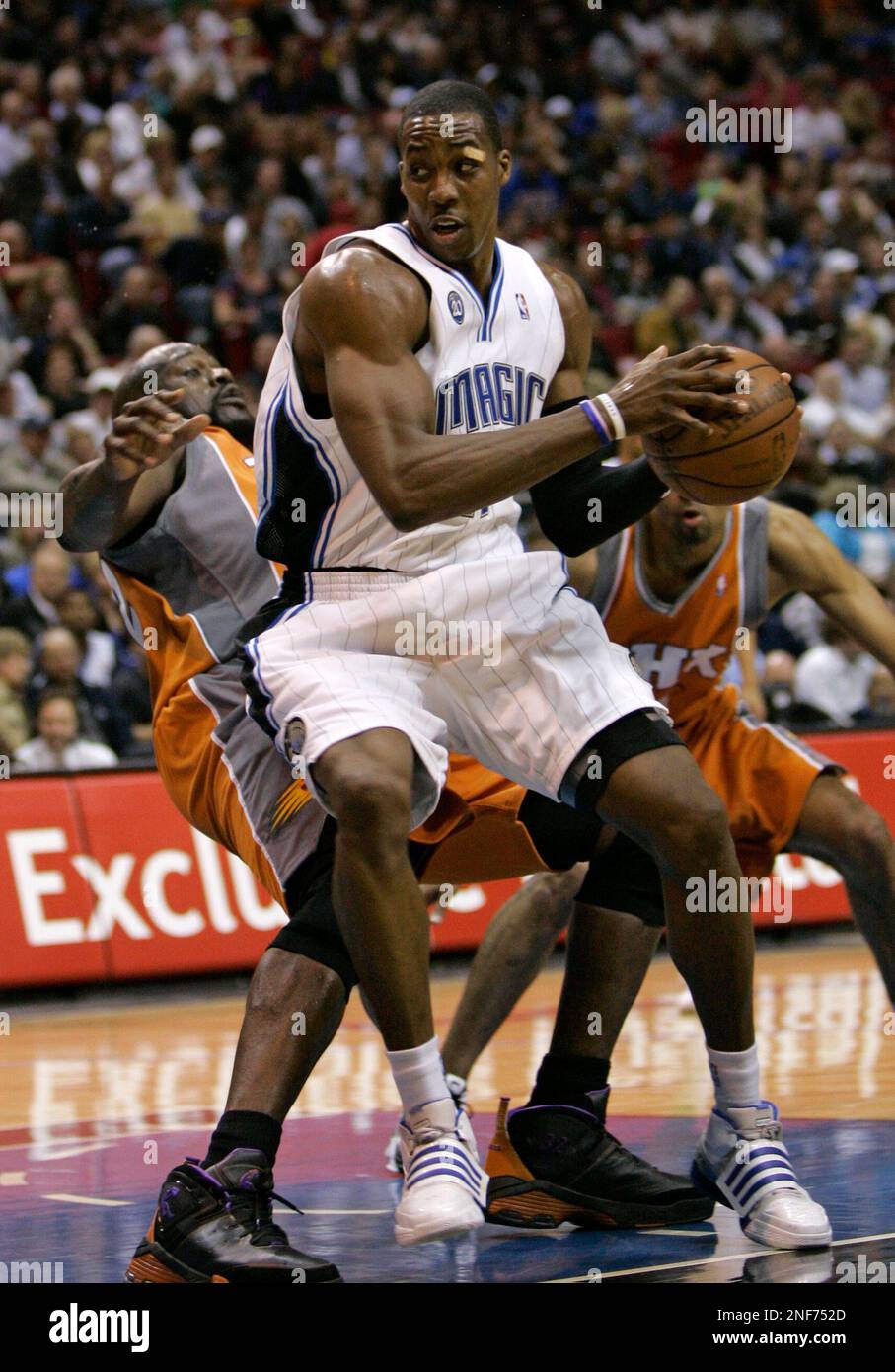 Phoenix Suns center Shaquille O'Neal, left, falls to the floor as he ...