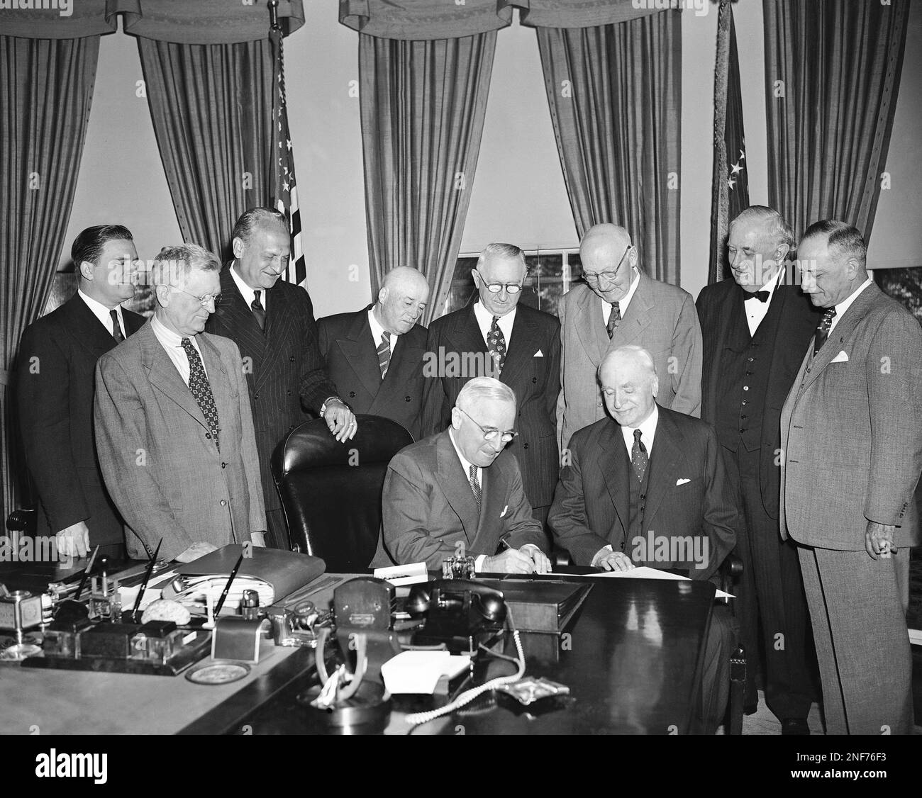 President Harry Truman signs bill with former Secretary of State ...