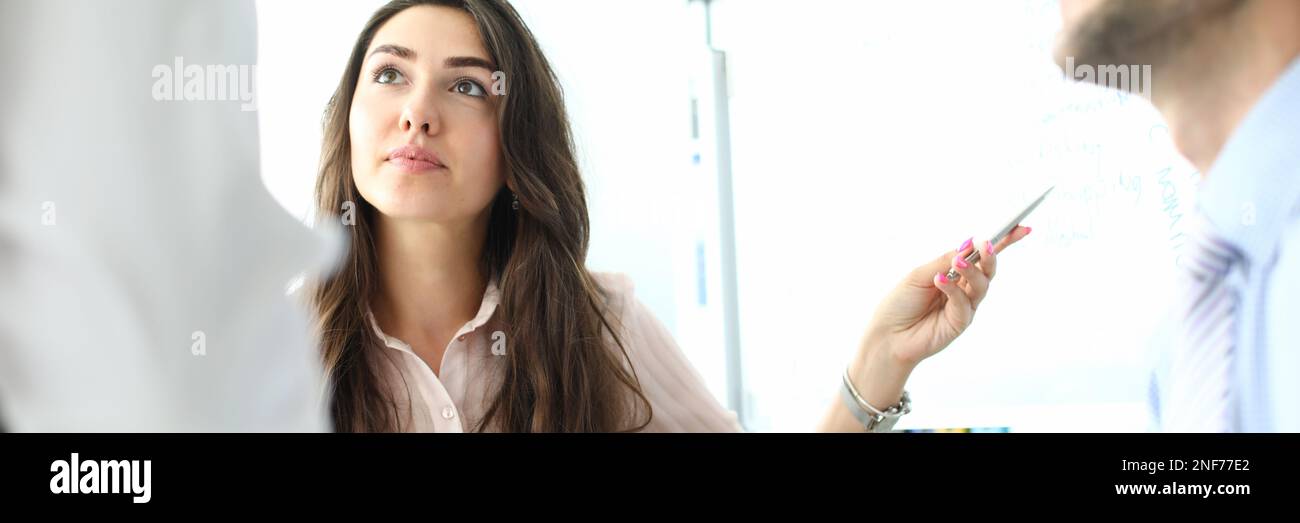 Serious professional female consultant consulting client at meeting ...