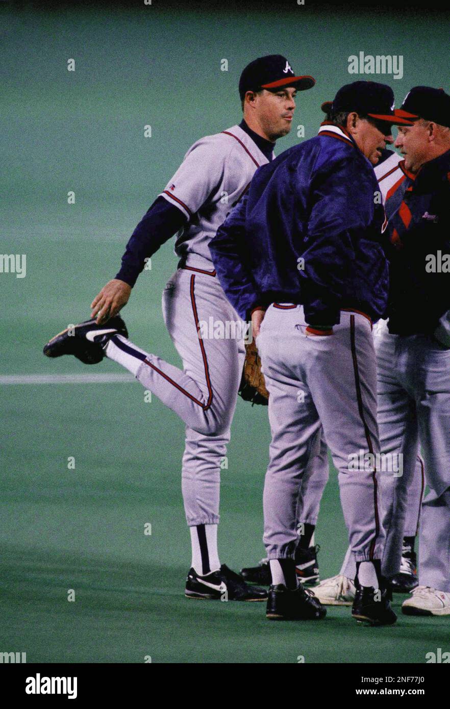 Atlanta Braves starting pitcher Greg Maddux stretches his leg after ...