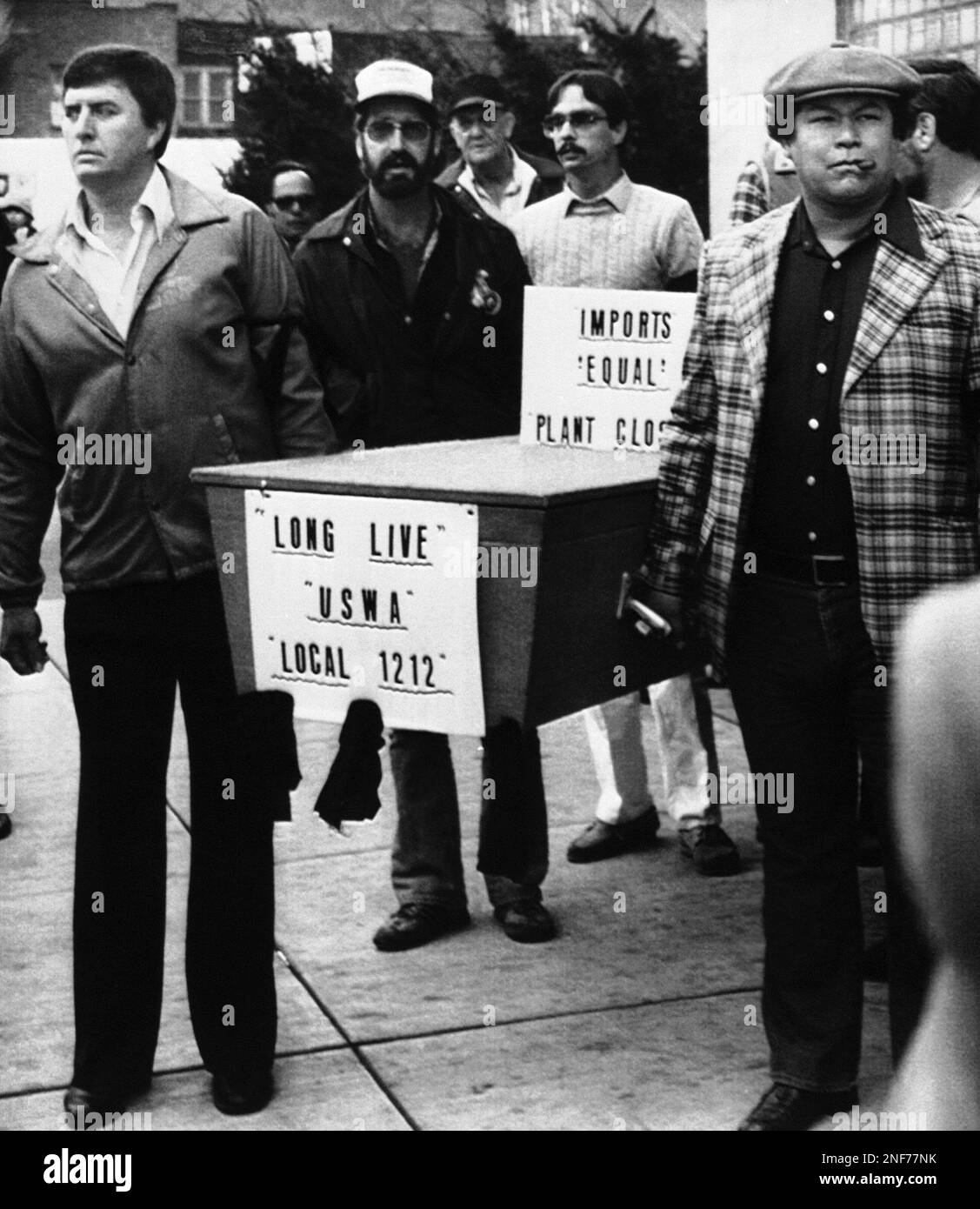 United Steelworkers of America union members hold an empty coffin ...