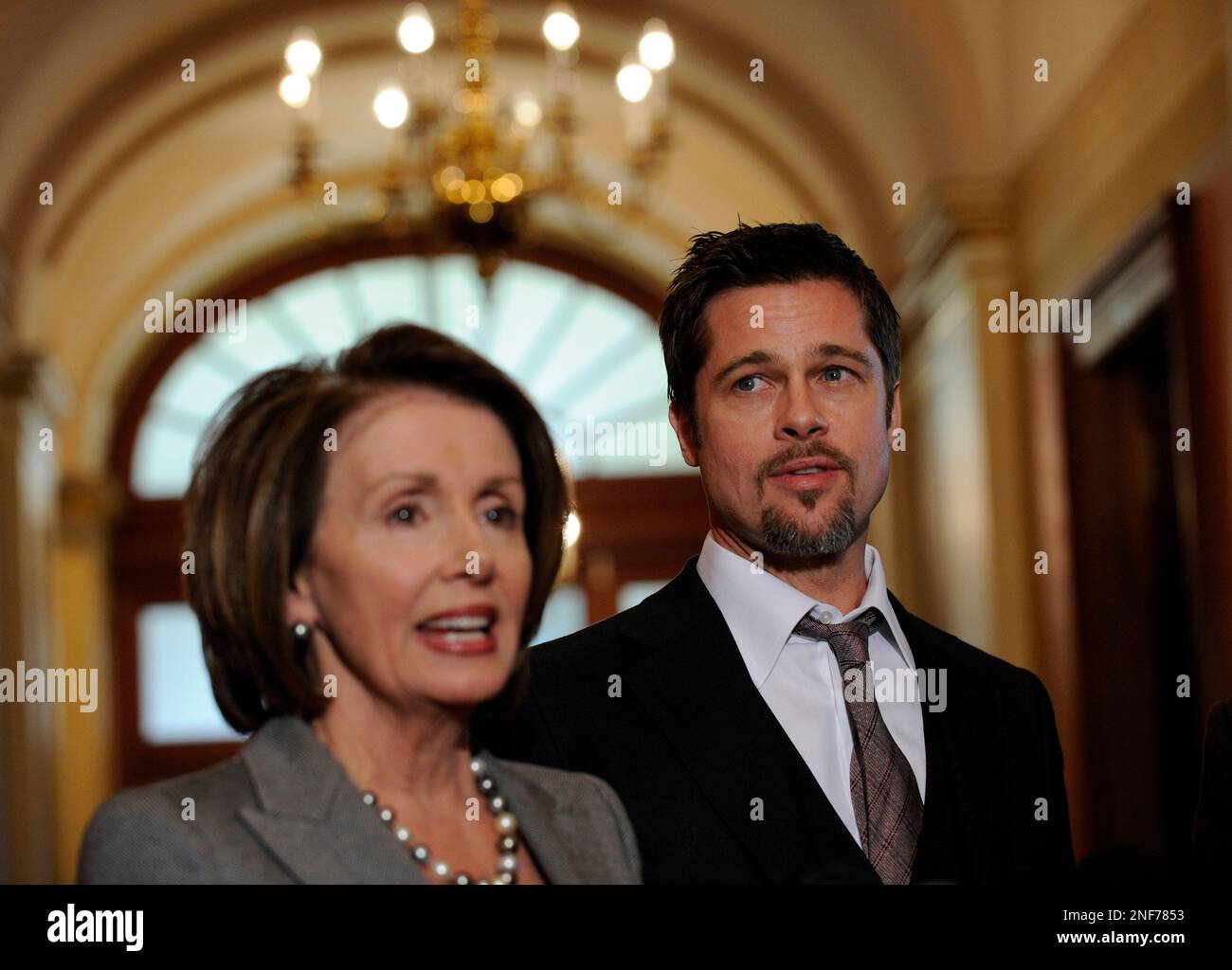 Actor Brad Pitt stands with House Speaker Nancy Pelosi of Calif., prior ...