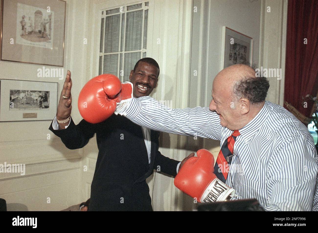 New York Mayor Ed Koch, right, dons boxing gloves while throwing a mock ...