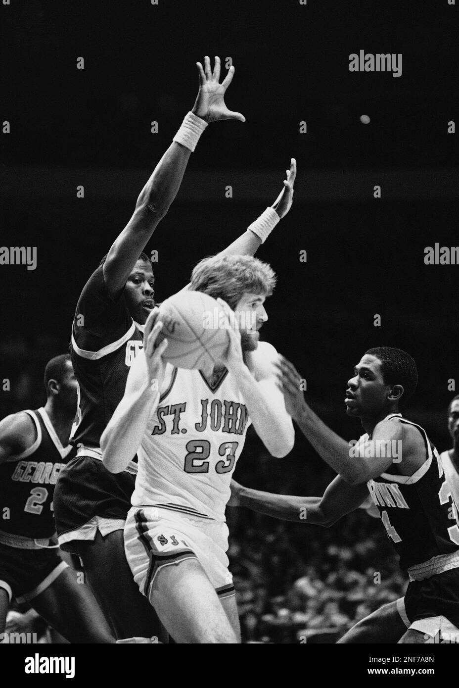 St. John’s Bill Wennington (23) holds the ball while Georgetown’s ...