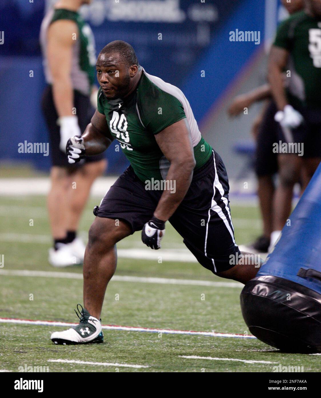 Michigan defensive lineman Terrance Taylor runs a football drill at the ...