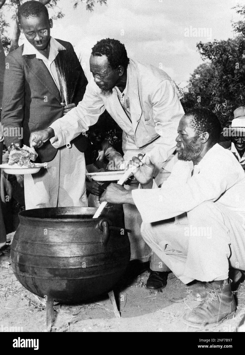 Three headmen of the Bamangwato Tribe prepare supper while awaiting the ...