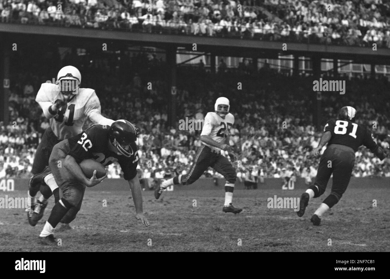 Chicago Cardinals end Dick "Night Train" Lane (81), pulls down halfback ...