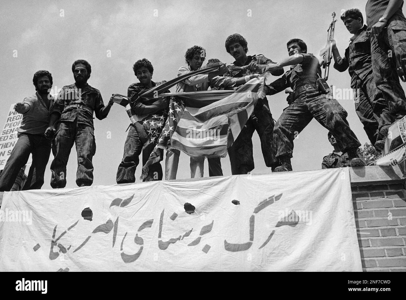 Islamic militia guarding the U.S. embassy tear an American flag to ...
