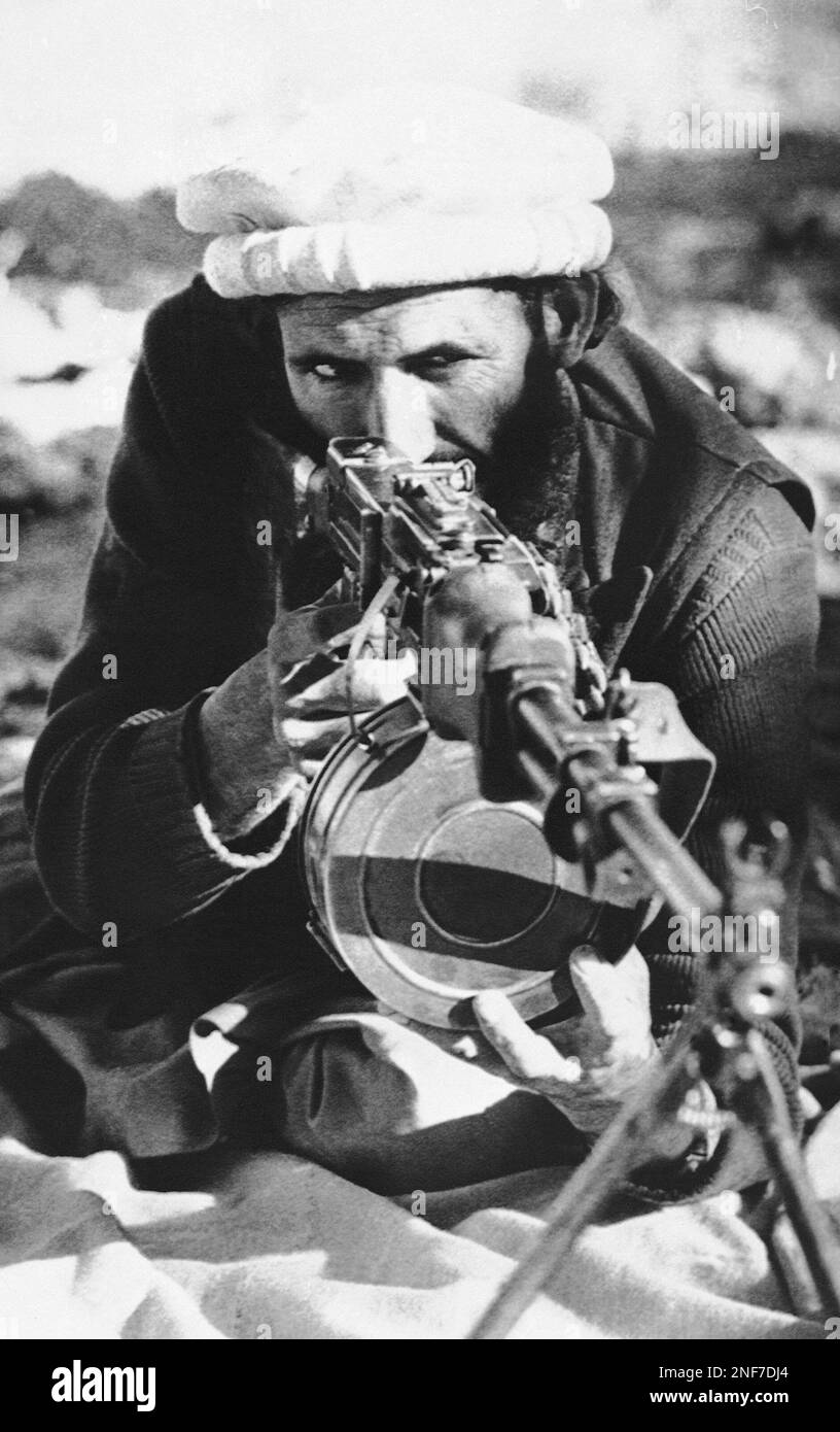 An Afghan tribal rebel poses for a photographer behind the sights of a ...