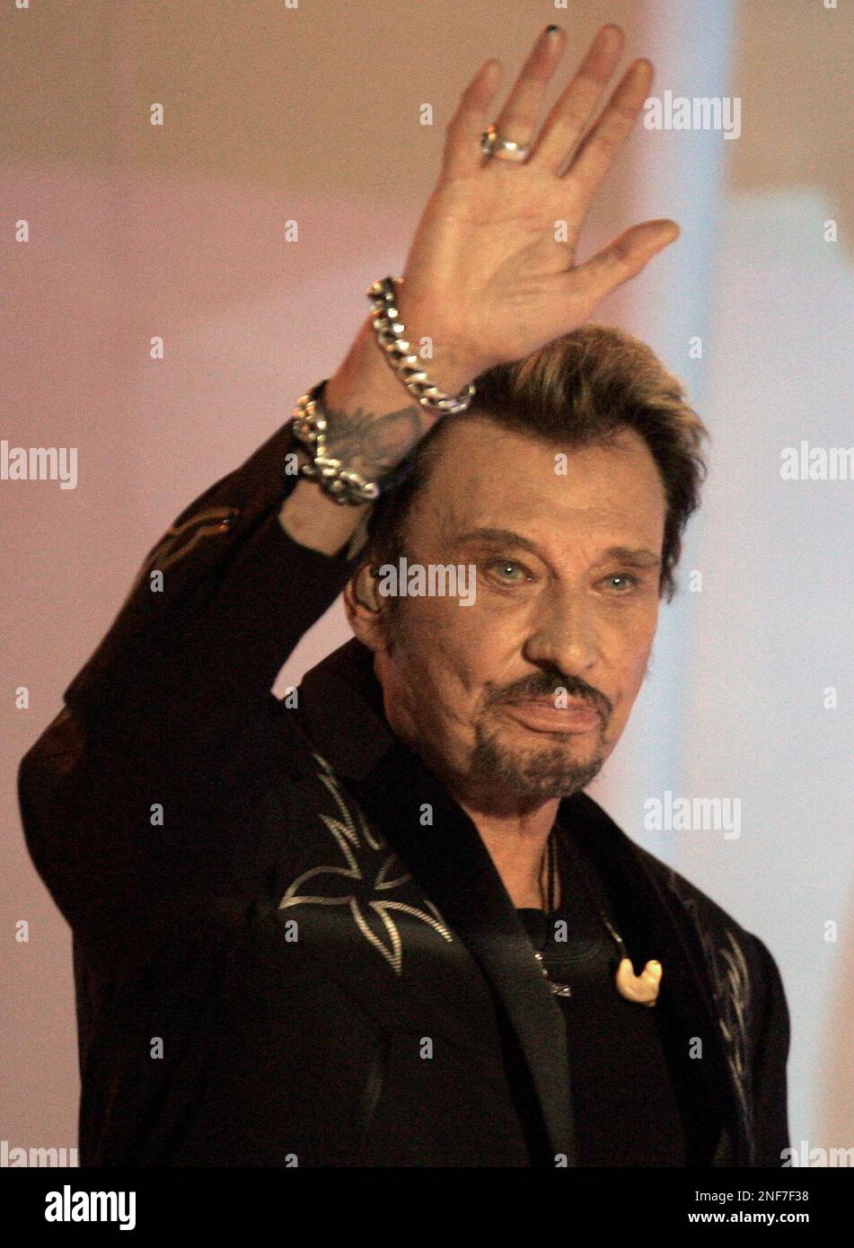 French singer Johnny Halliday gestures before receiving an Honor award ...