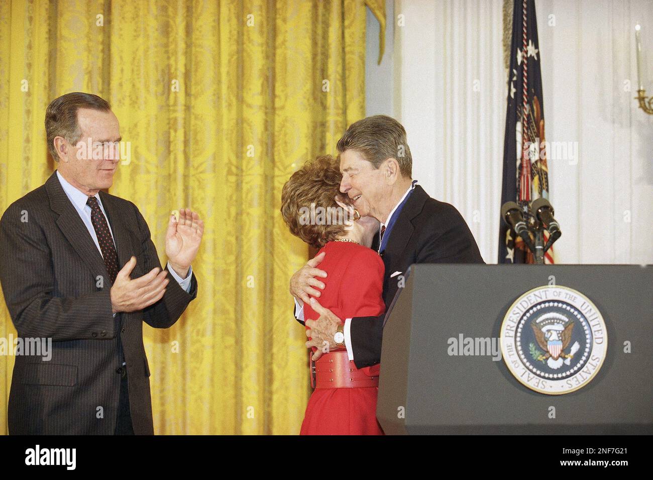 Former President Ronald Reagan gets a hug from his wife Nancy as ...